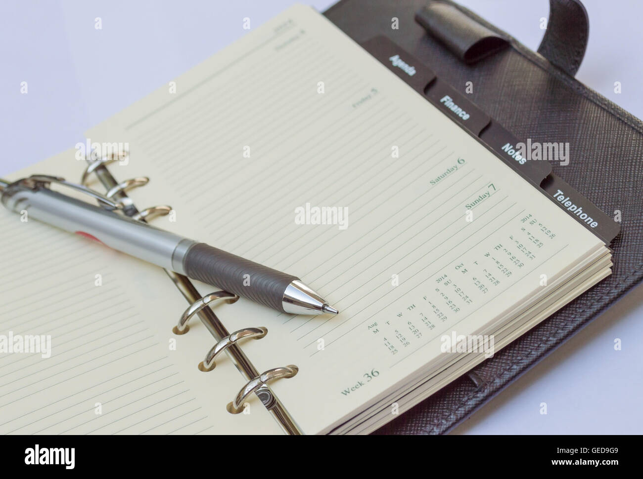 Leather notebook and pen Stock Photo - Alamy