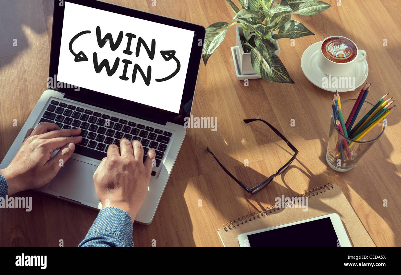 WIN WIN man hand on table Business, coffee, Split tone Stock Photo - Alamy