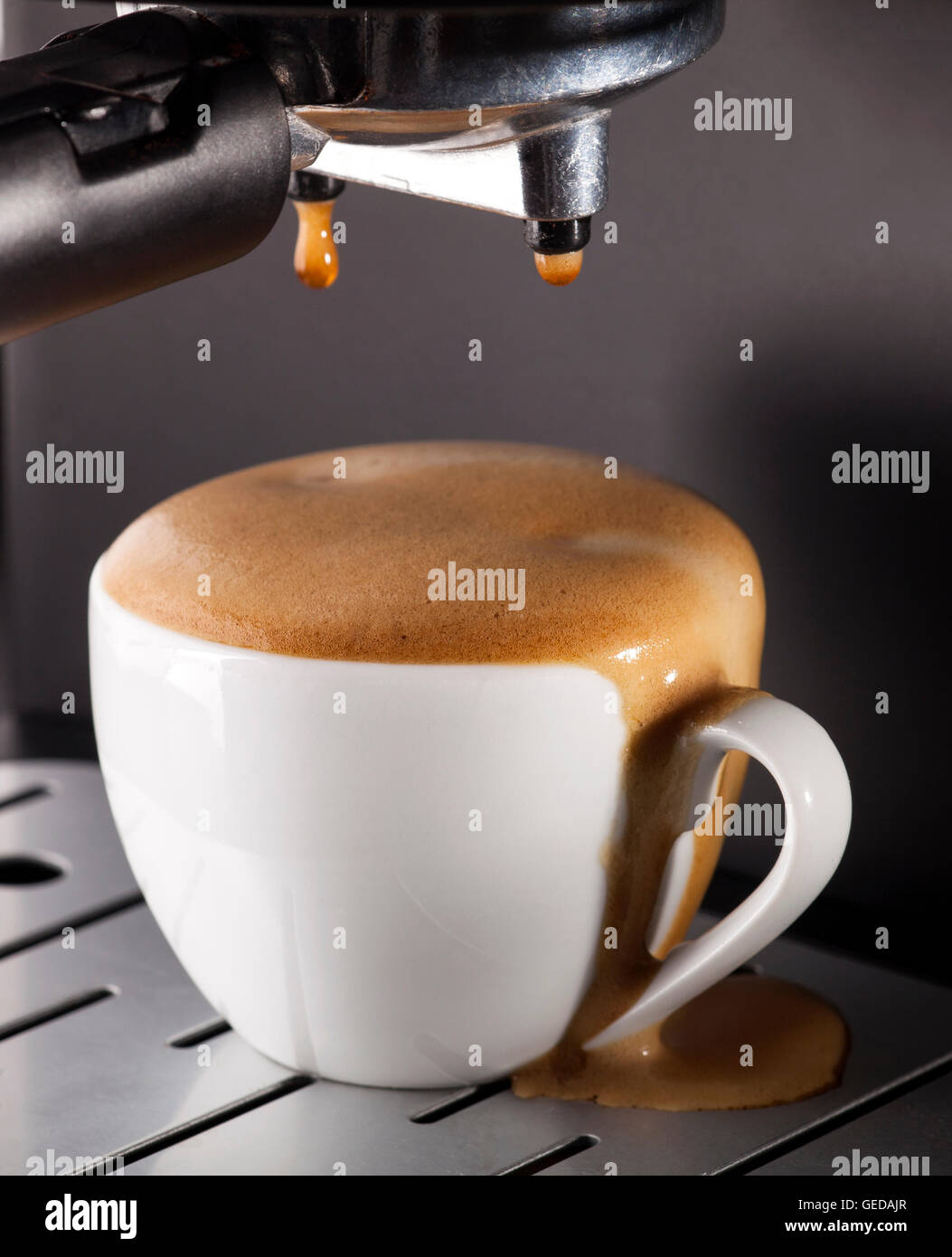 Espresso pouring from coffee machine Stock Photo - Alamy