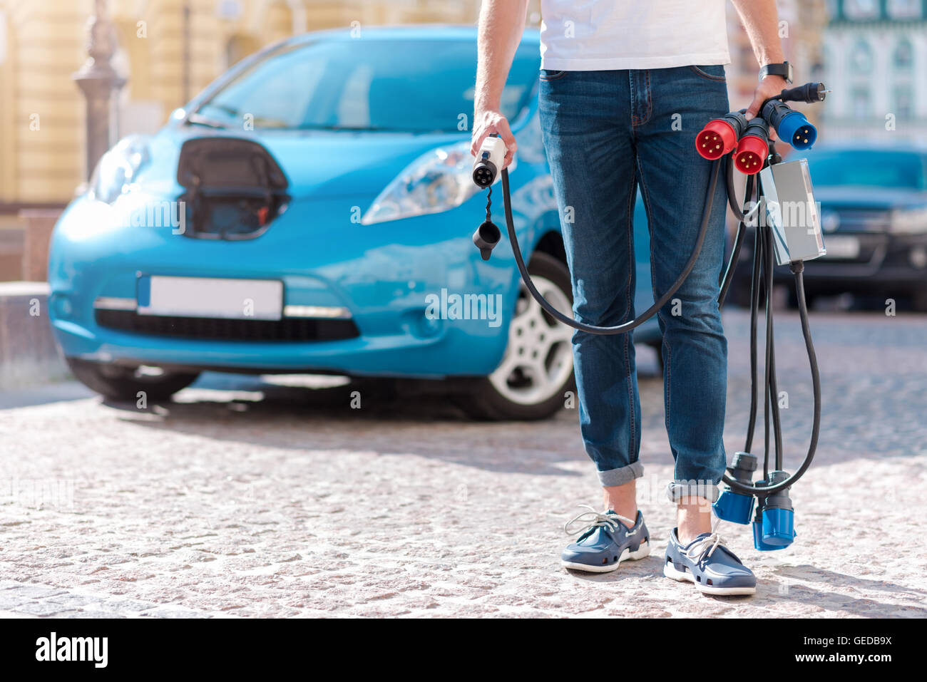 Man holding many power cables Stock Photo - Alamy