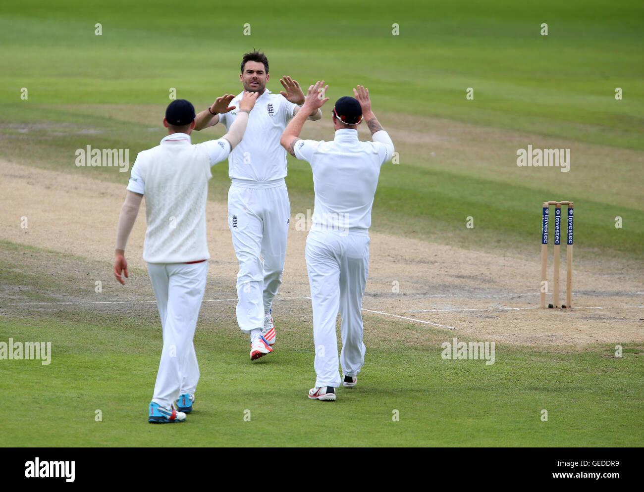 England's James Anderson (centre) celebrates with Stuart Broad (left ...