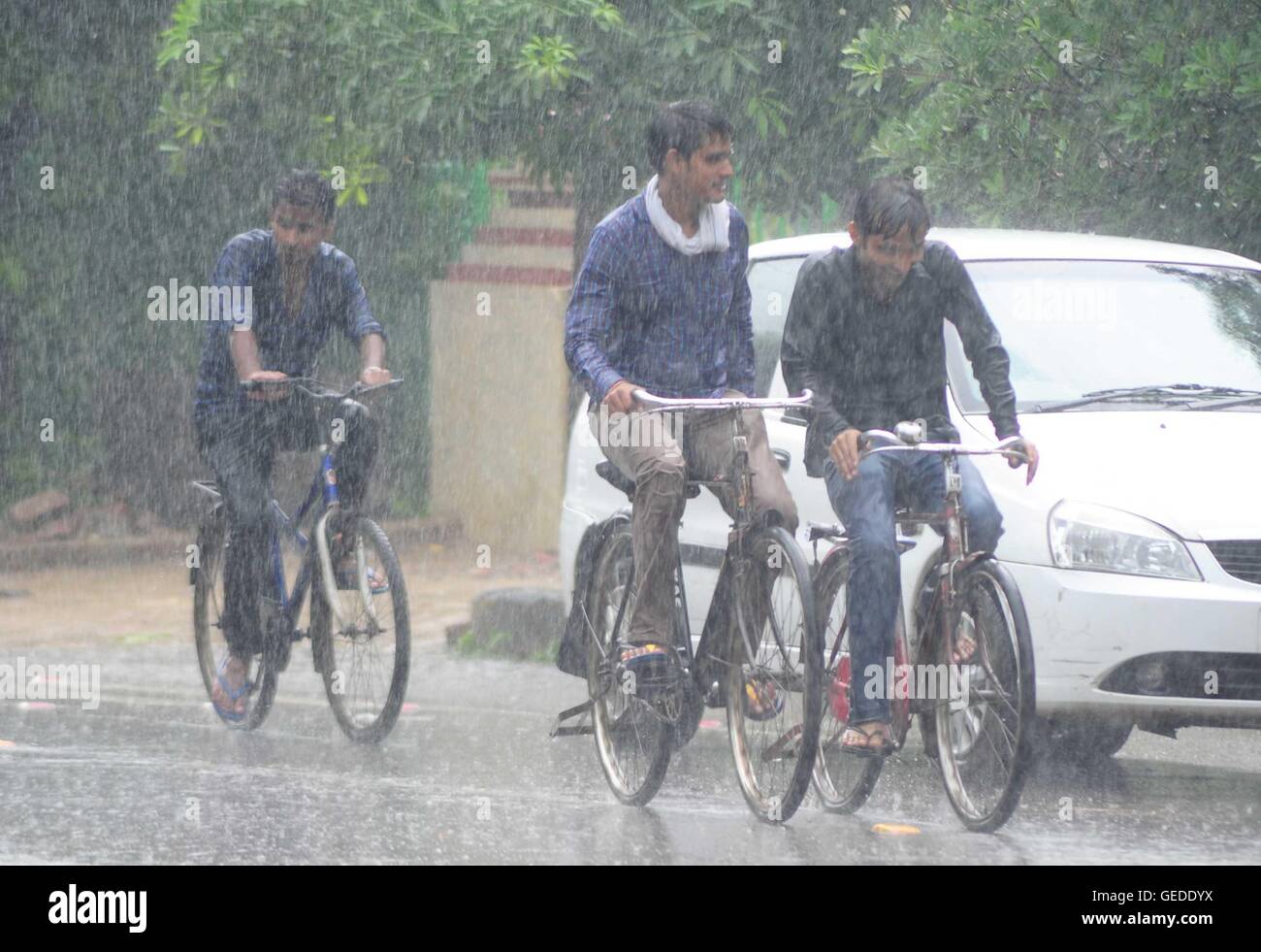 Allahabad, India. 25th July, 2016. Children paddle cycle during heavy ...