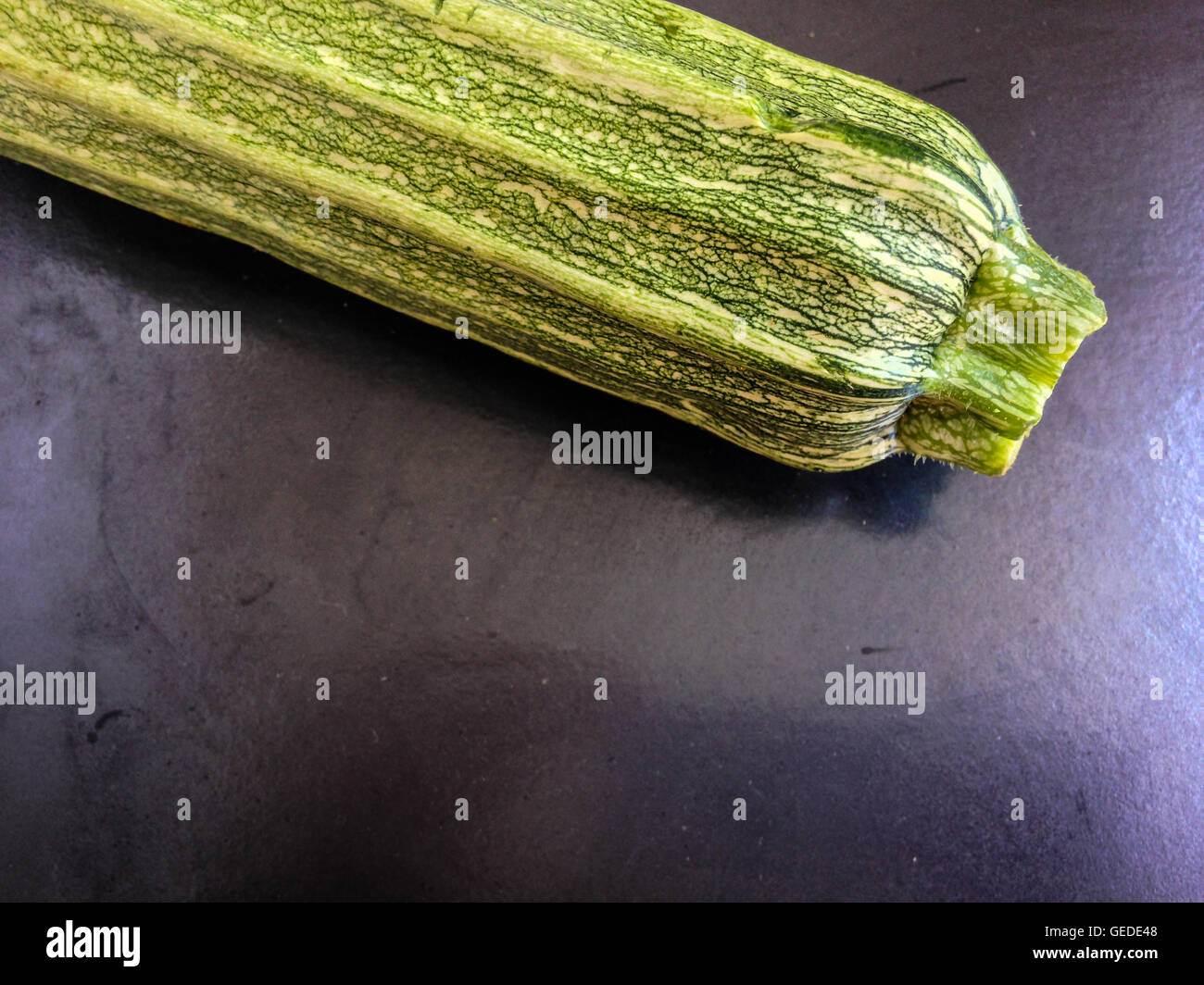 Vegetable on gray textured background. Green zucchini / squash Stock ...