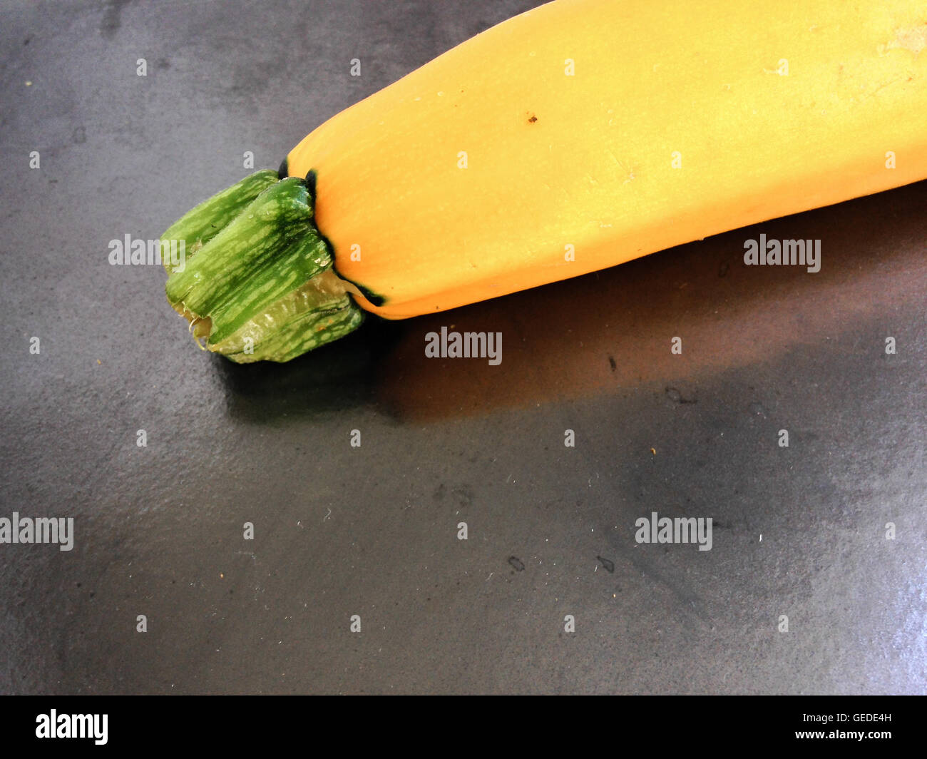 Vegetable on gray textured background. Yellow zucchini / squash Stock ...