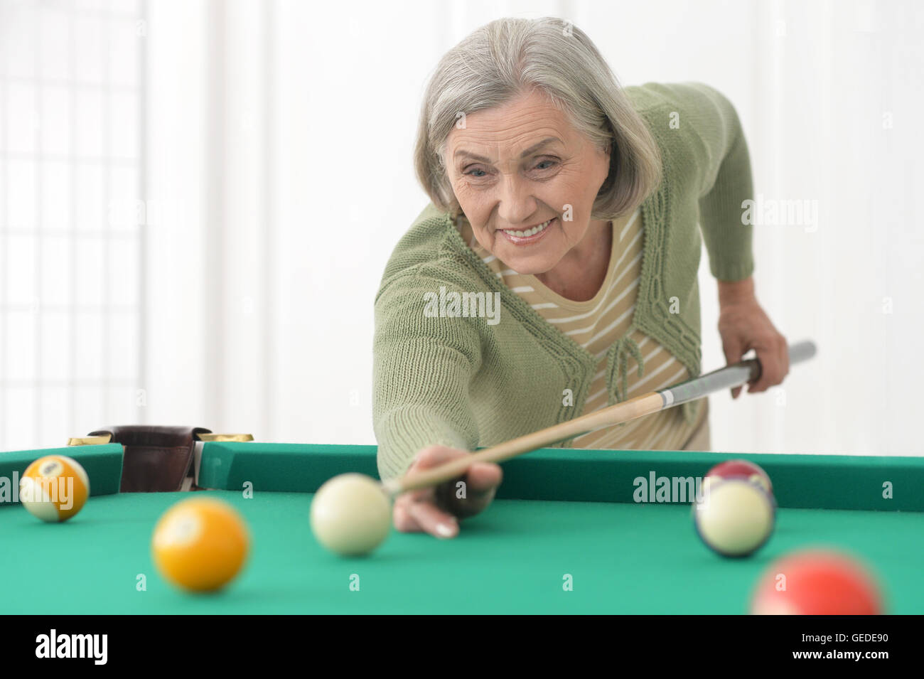 Mature woman Playing billiard Stock Photo - Alamy