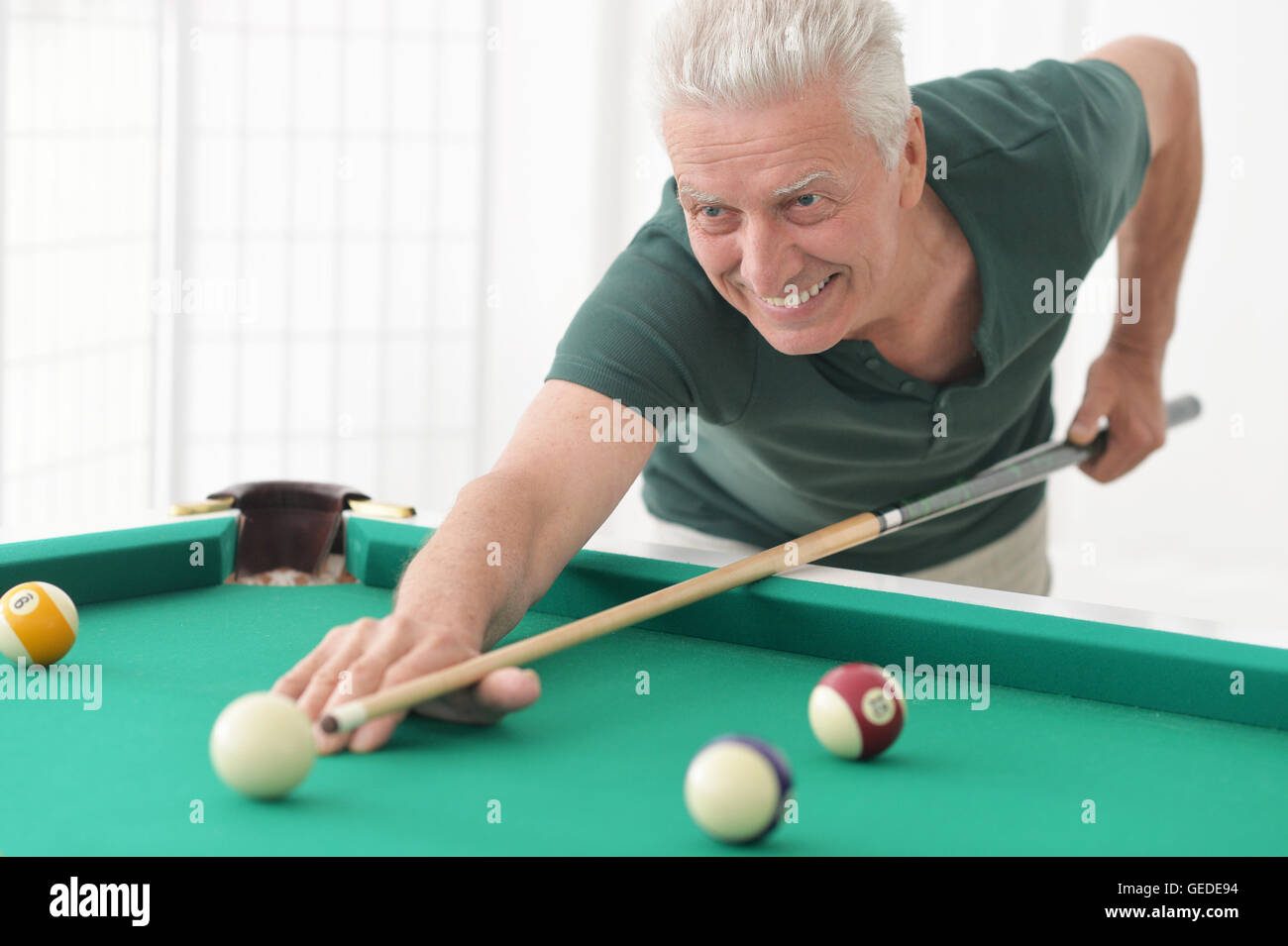 Man playing billiards green billiard hi-res stock photography and ...