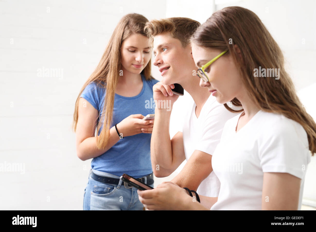 A group of teenagers with cell phones during a break classroom Stock ...
