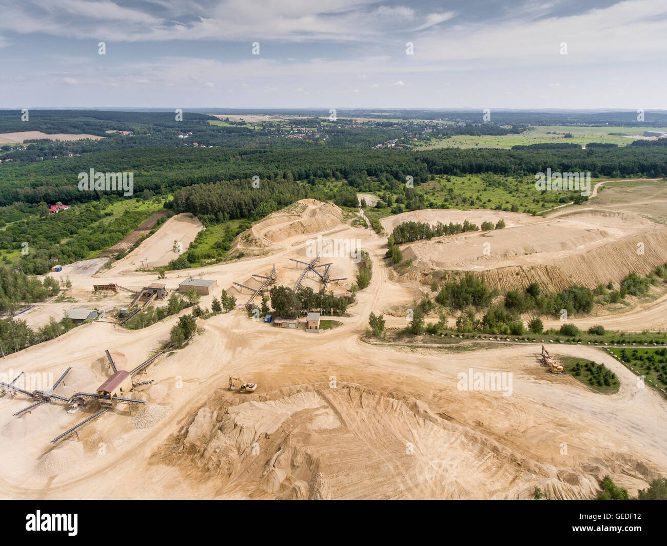Aerial view of excavator and truck working on the field of sand mine in ...