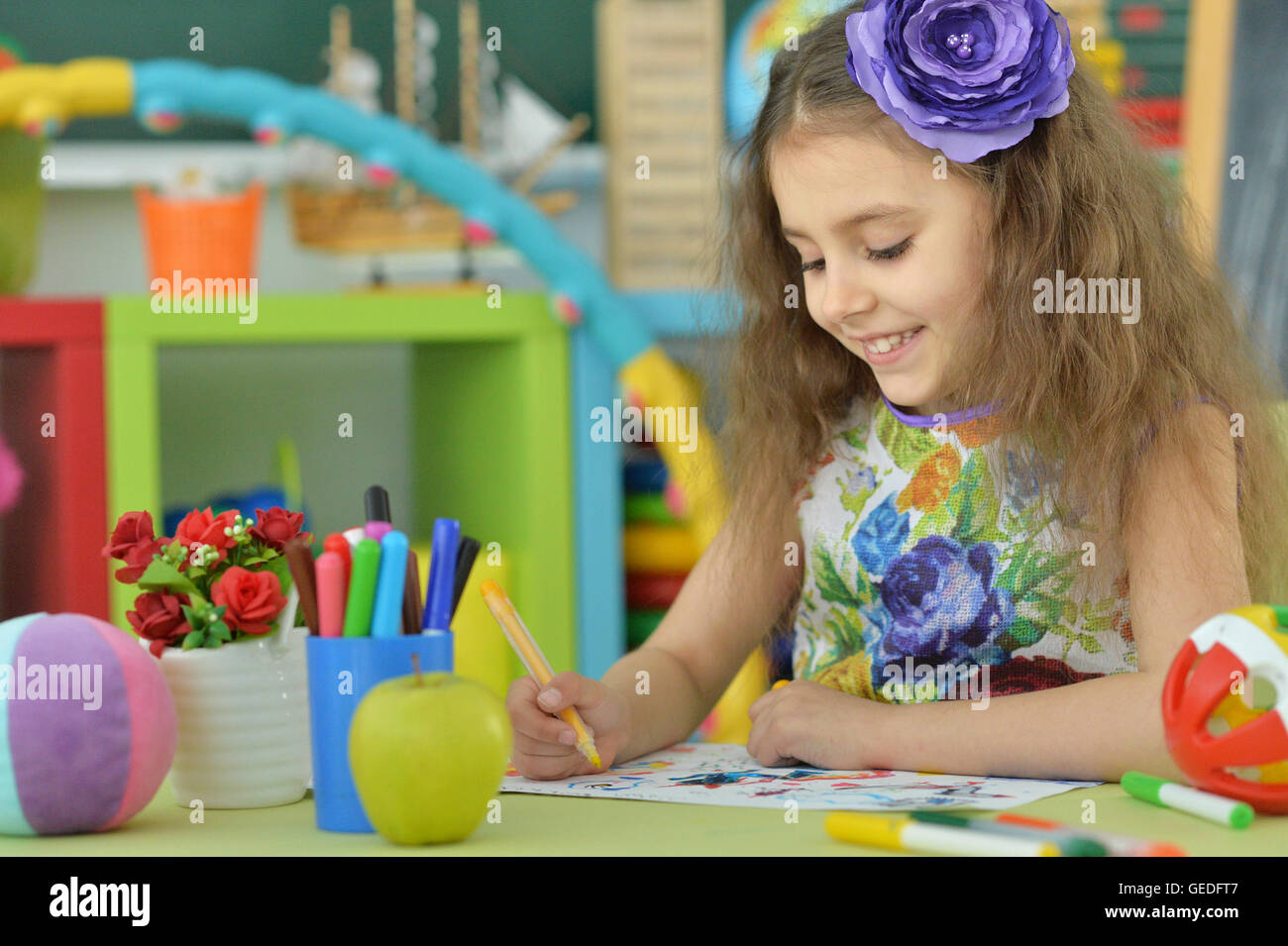 Little girl drawing at class Stock Photo - Alamy