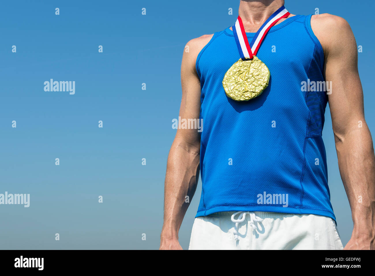 Athlete standing with gold medal hanging from a red white and blue ...