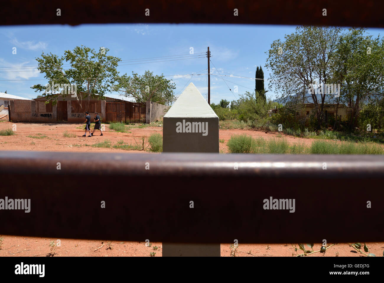 A gap in the current metal border wall shows teens in Mexico and the ...
