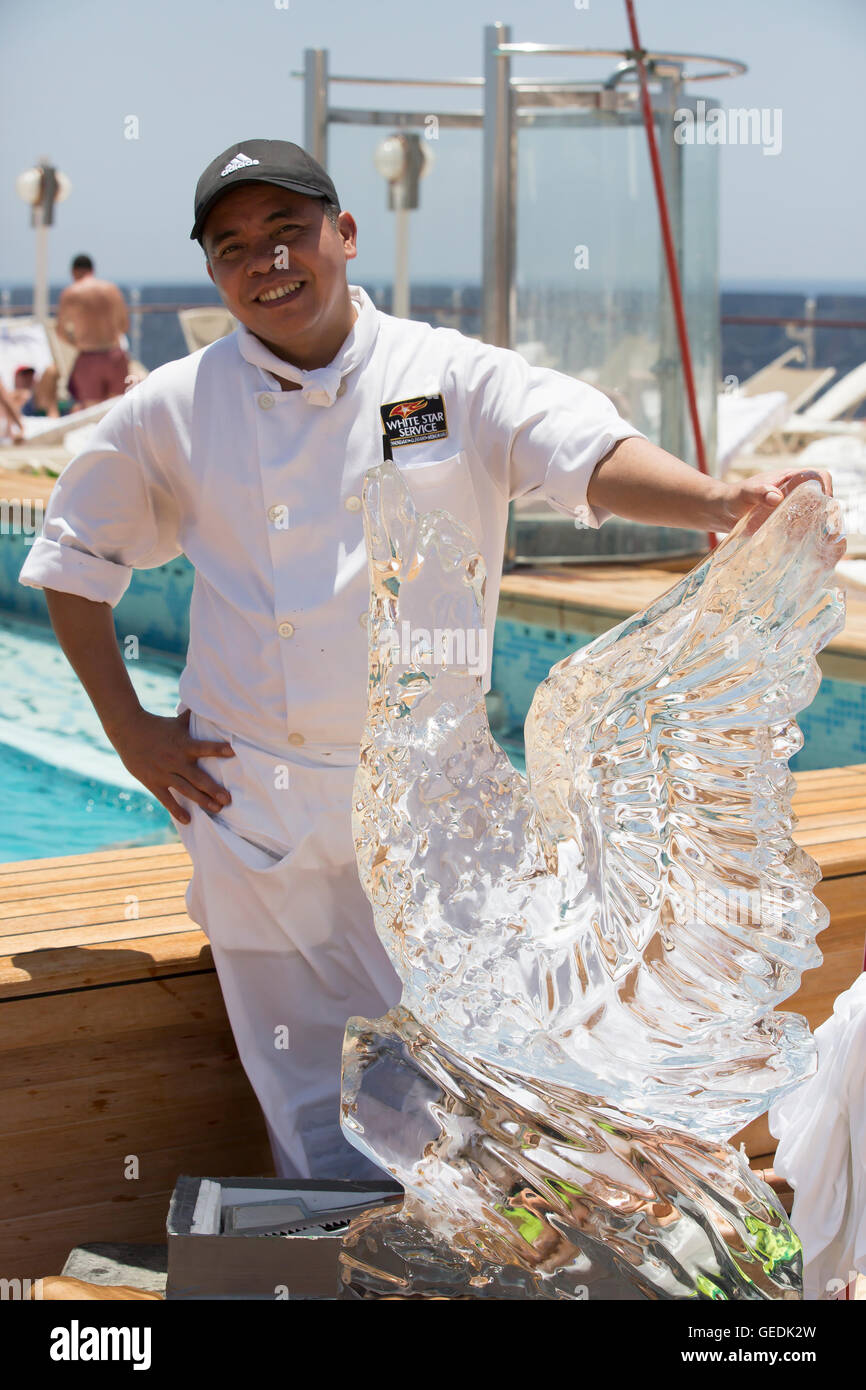 A member of the ships crew demonstrates ice carving on board Cunard's ...