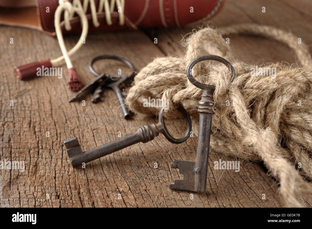 bunch of vintage keys with rope on old wooden plank Stock Photo - Alamy