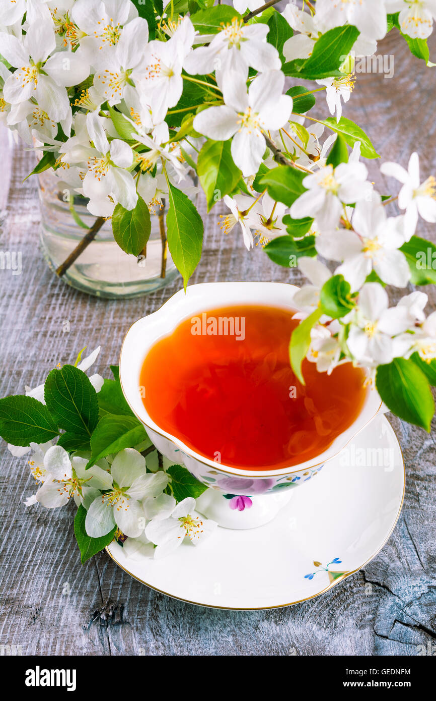 Cup of tea on wooden table and apple blossom. Tea time concept ...