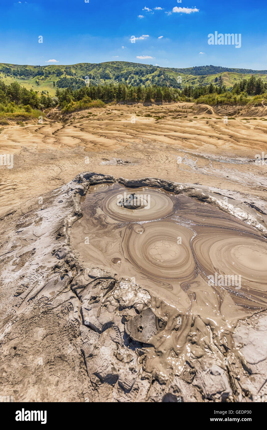 Bubble of gas bursting through the mouth of a Mud Volcano Stock Photo ...