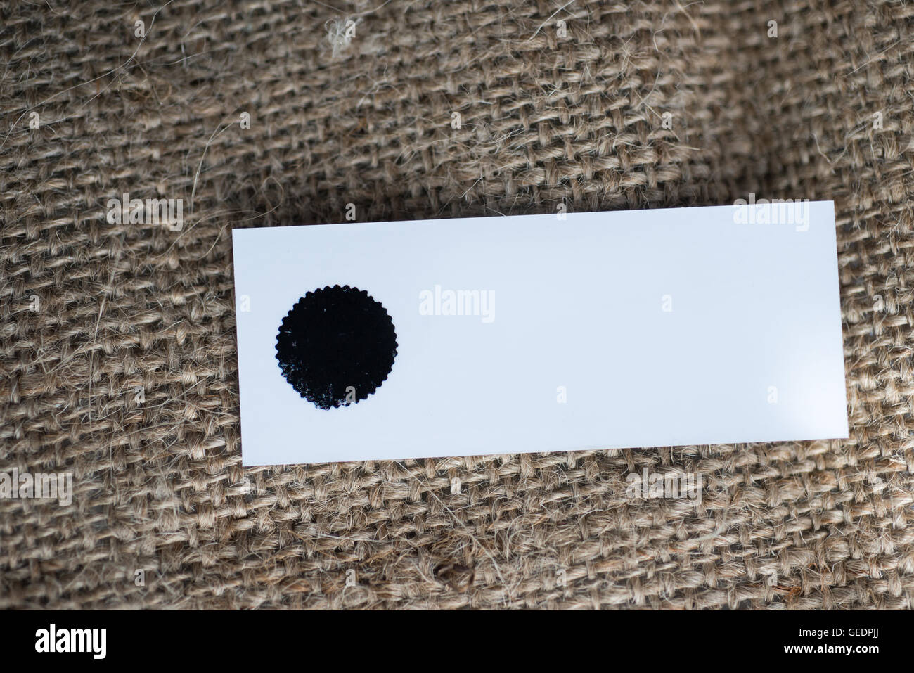 A business card or product label with space for copy shot on a hessian ...