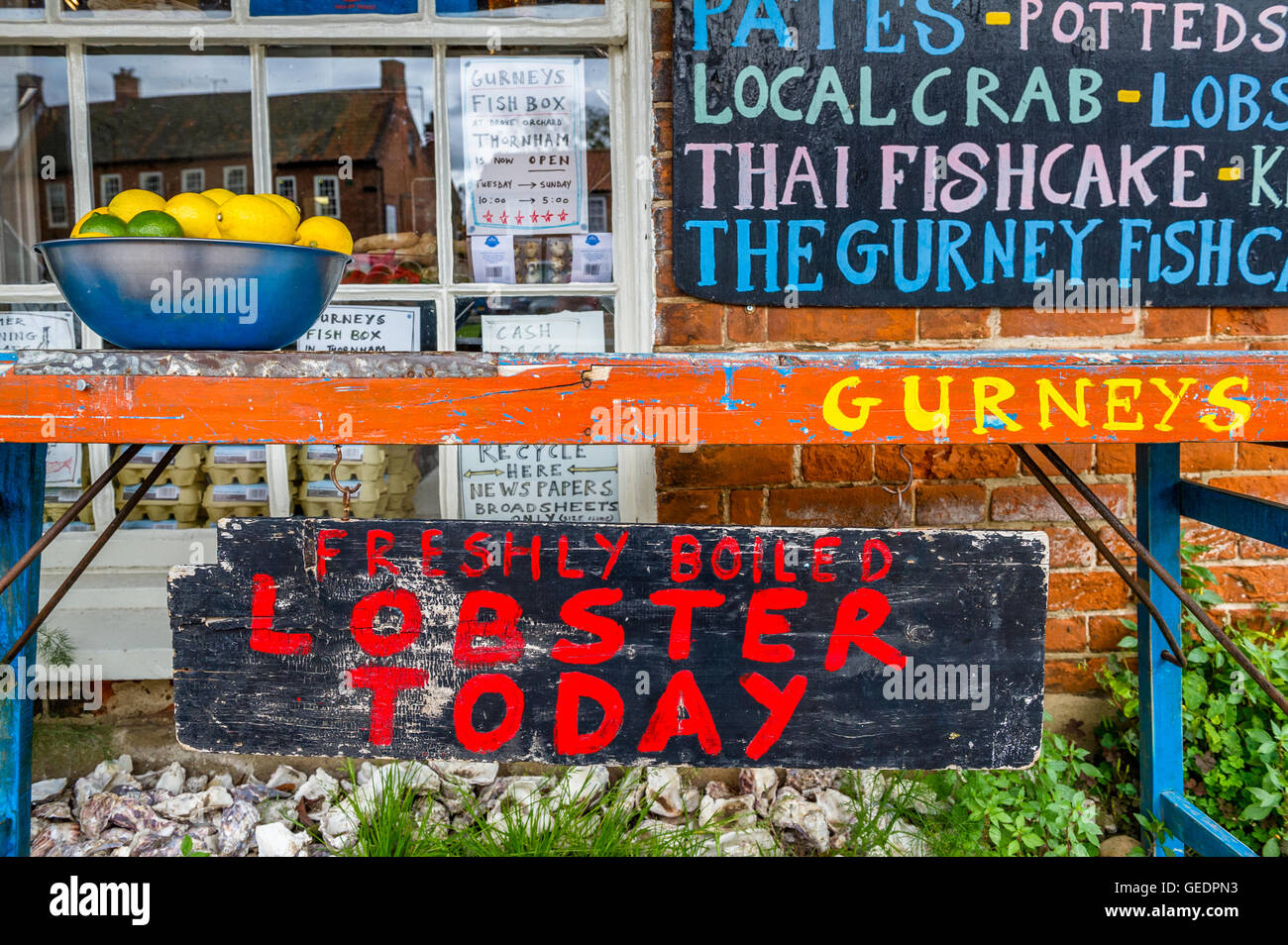 Signs for fresh fish, lobsters and other sea food outside a shop in ...