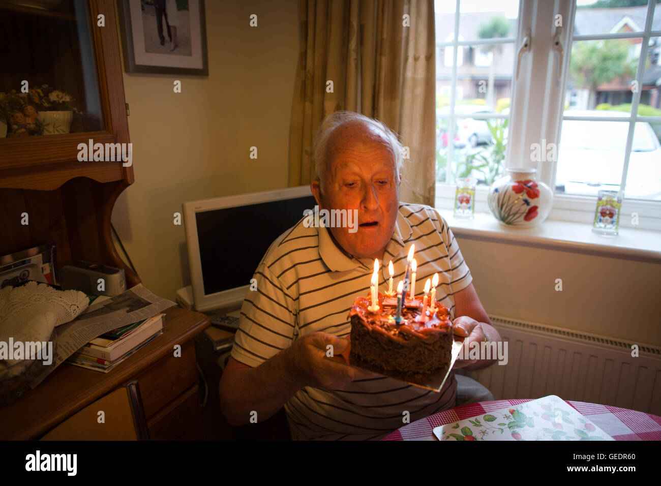 Old age pensioner enjoying his birthday (83 years) celebrations at home ...