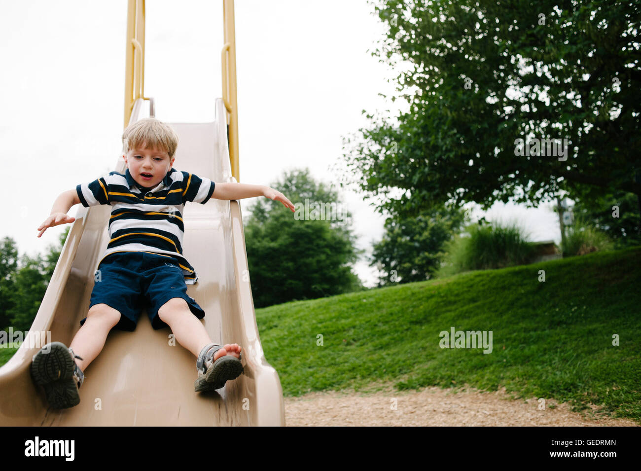 Young Boy on Slide Stock Photo - Alamy