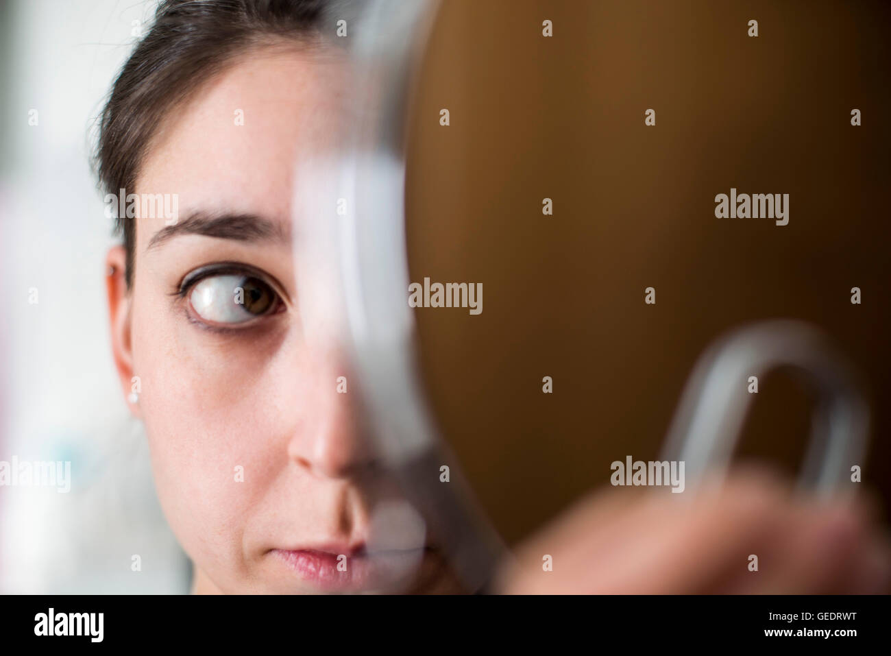 Woman Looking into Mirror Stock Photo - Alamy