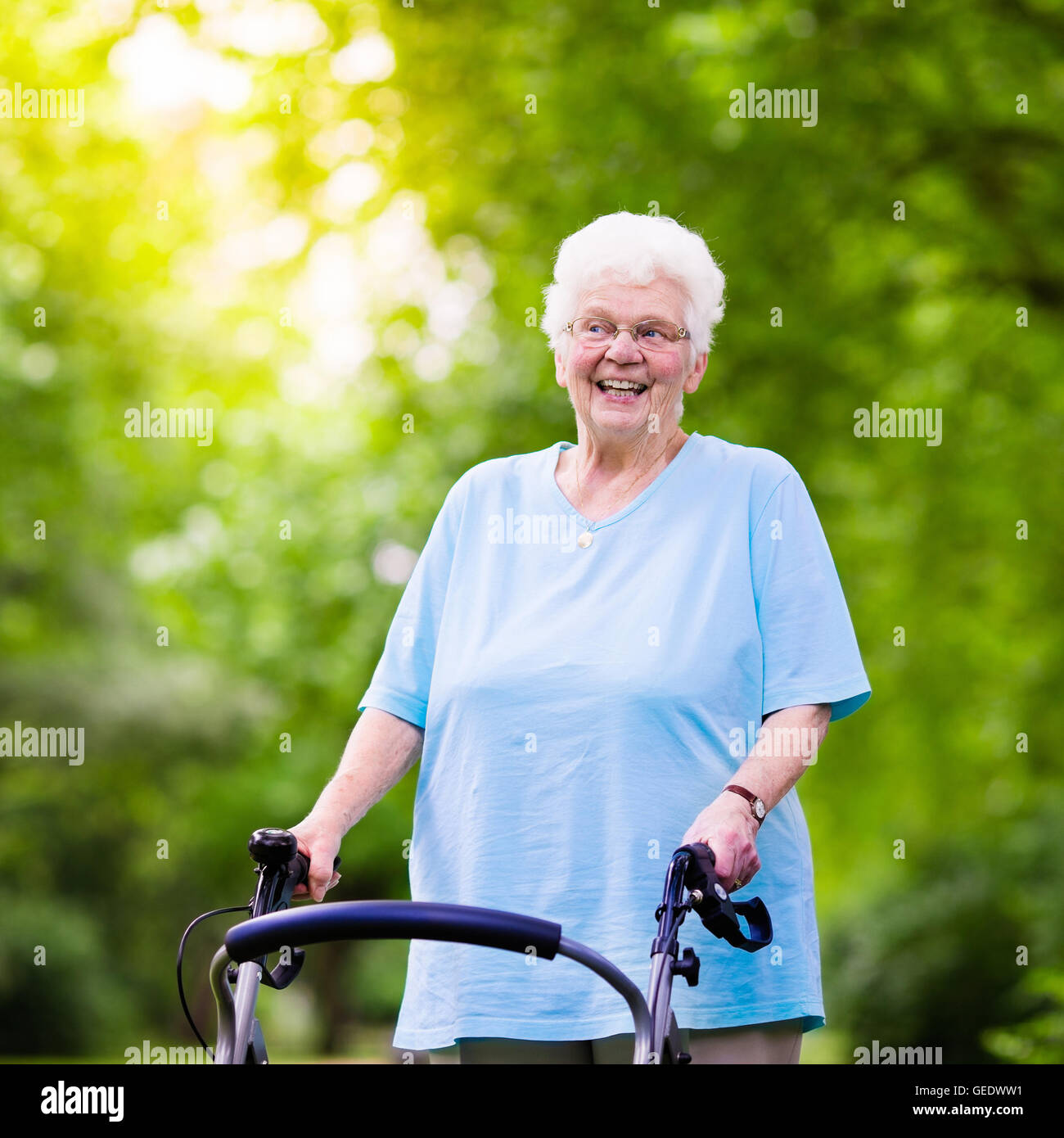 Happy senior handicapped lady with a walking disability enjoying a walk ...