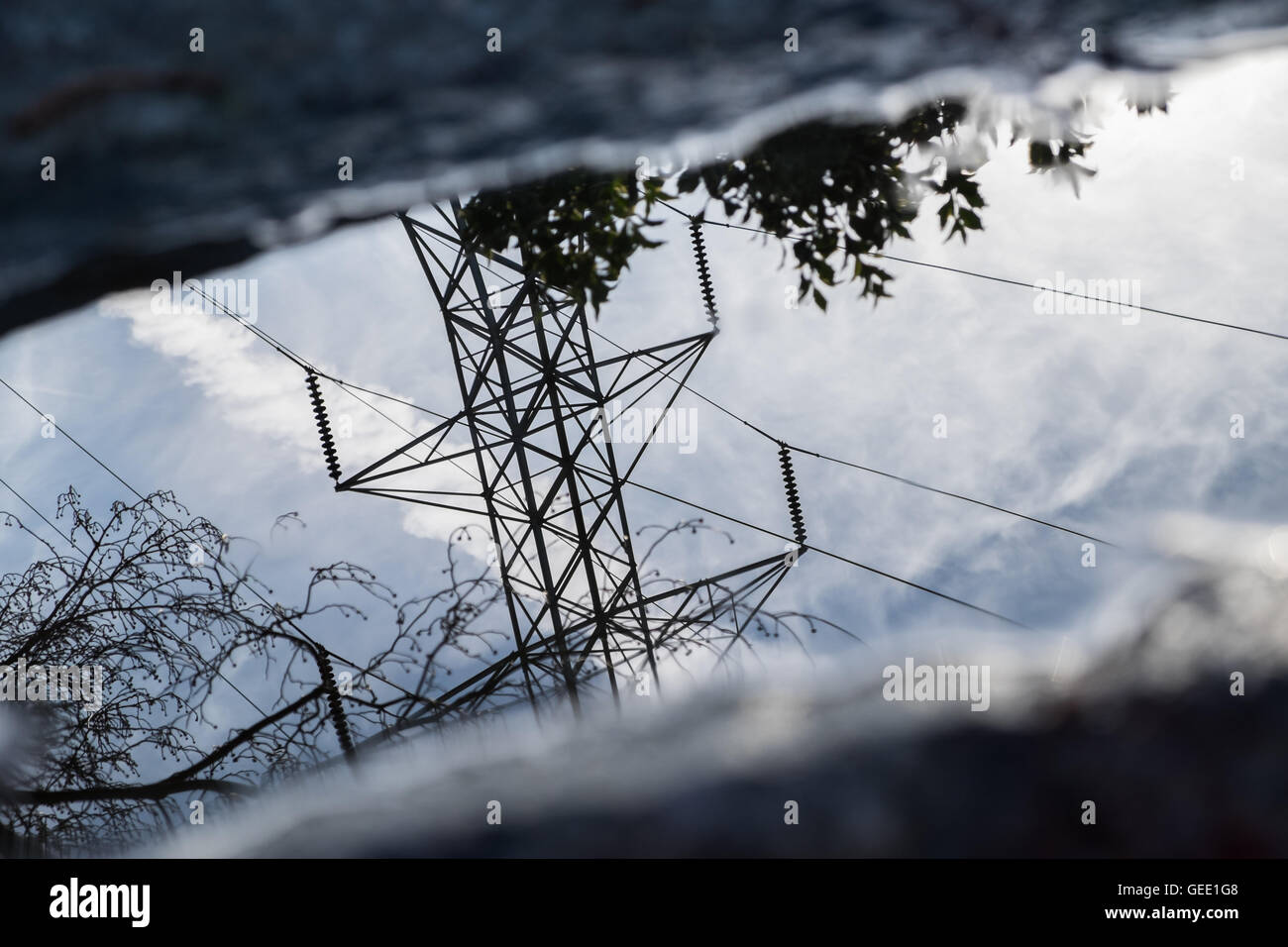 Reflection of power lines in a puddle Stock Photo - Alamy