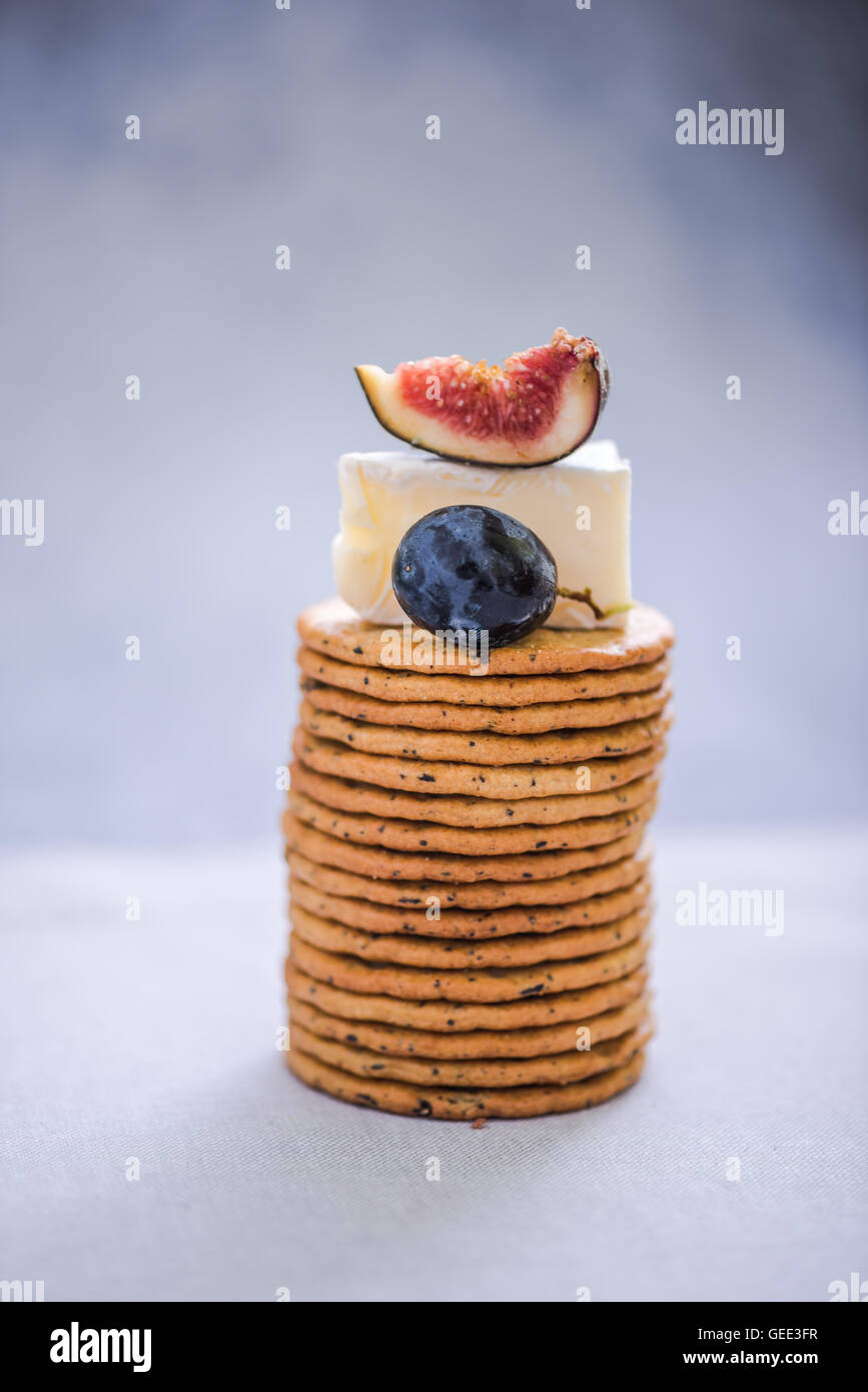 crackers with cheese grape and fig wedge Stock Photo - Alamy