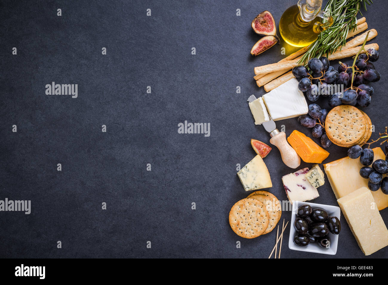 cheese selection border background on dark slate Stock Photo - Alamy