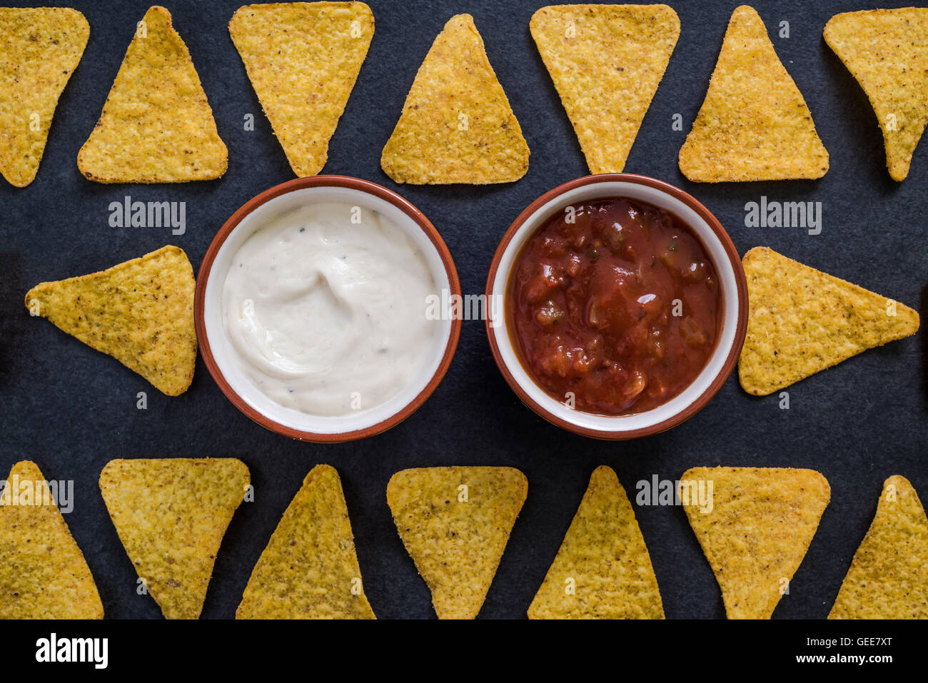 mexican nachos crisps with dip on dark slate Stock Photo - Alamy