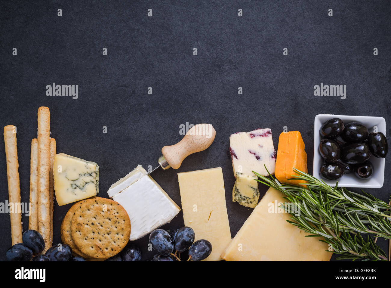 cheese selection border background on dark slate Stock Photo - Alamy