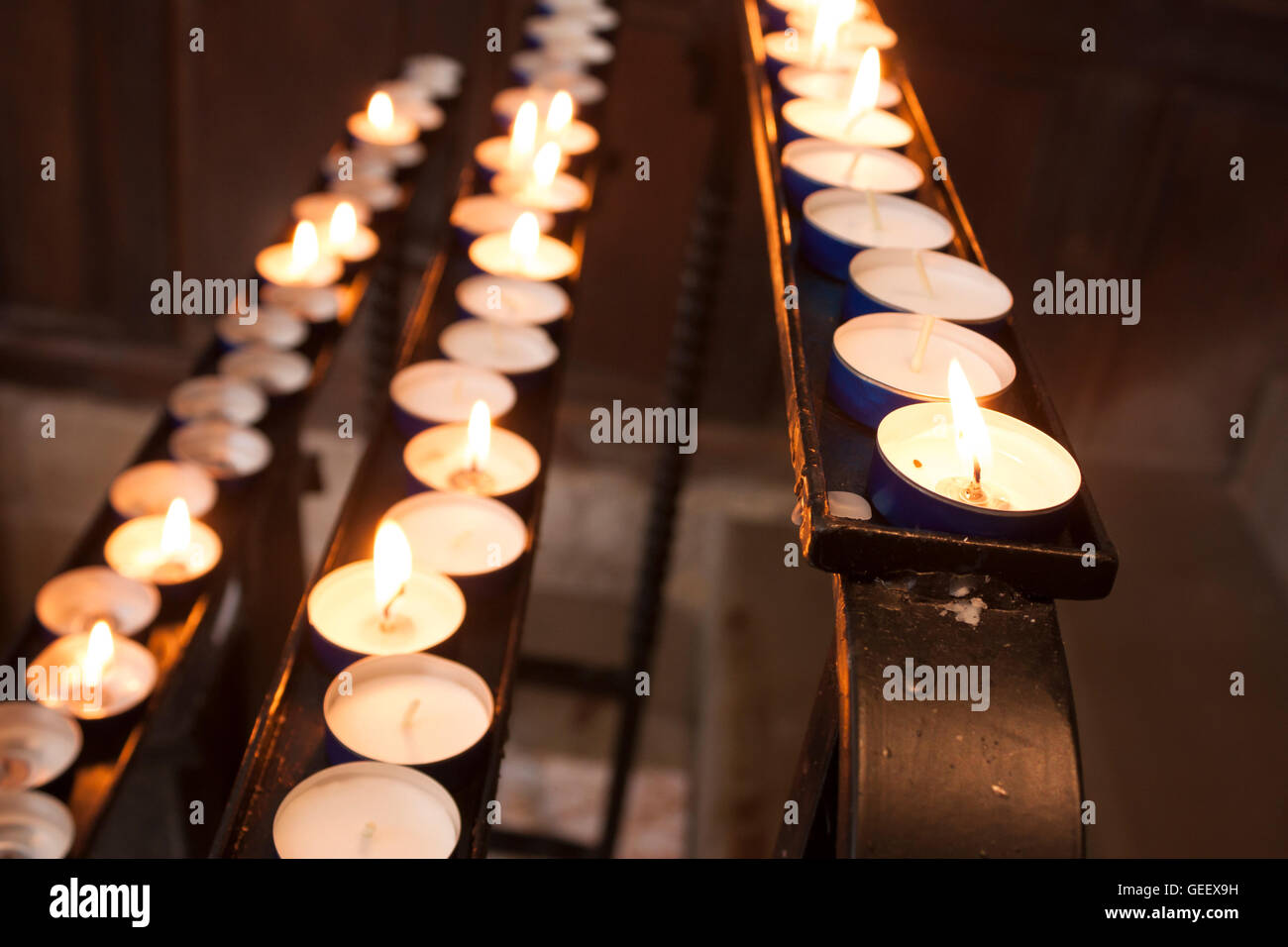 Line of lit candles Stock Photo - Alamy