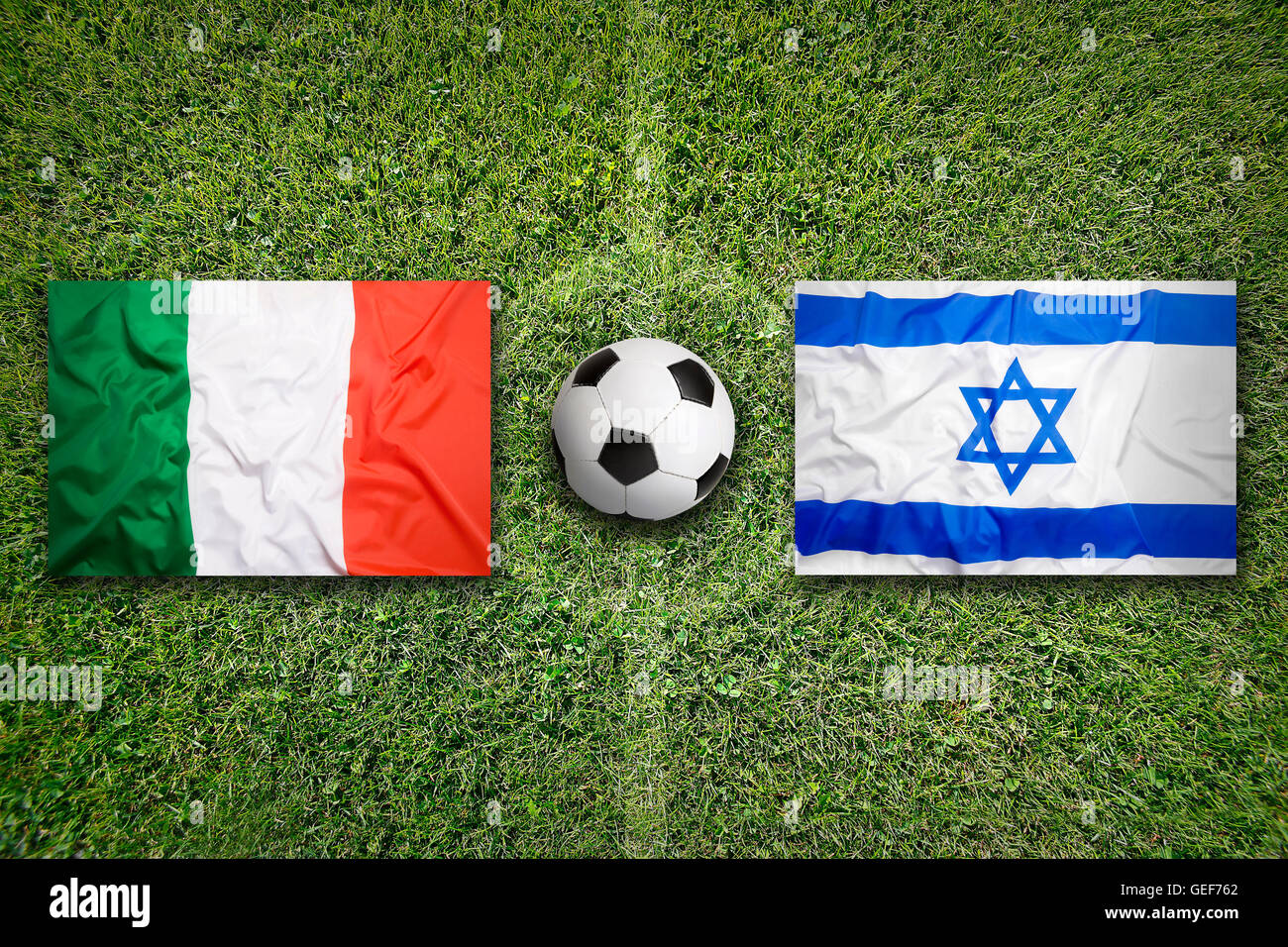 Italy vs. Israel flags on green soccer field Stock Photo - Alamy
