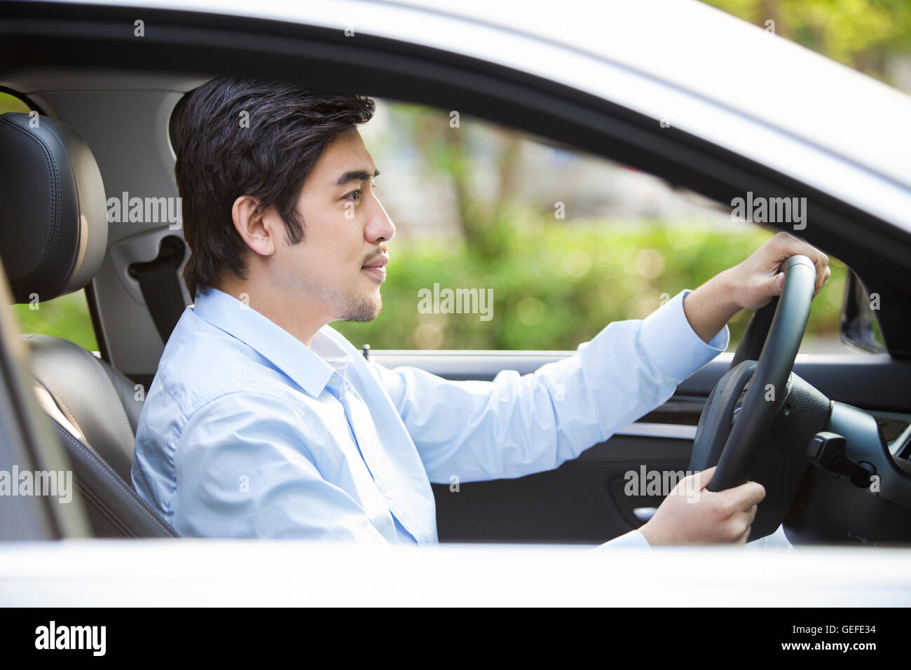 Young chinese man driving car hi-res stock photography and images - Alamy