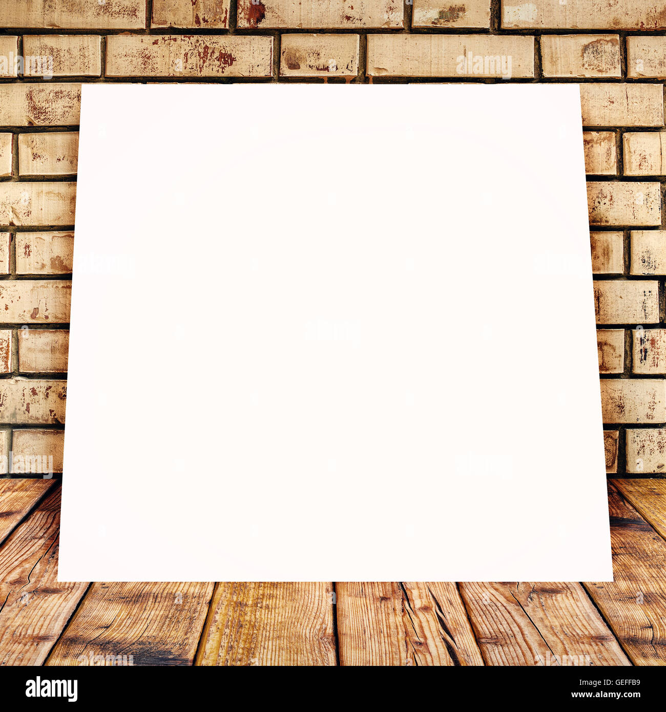 Blank square poster leaning on the wall as copy space for mock up ...