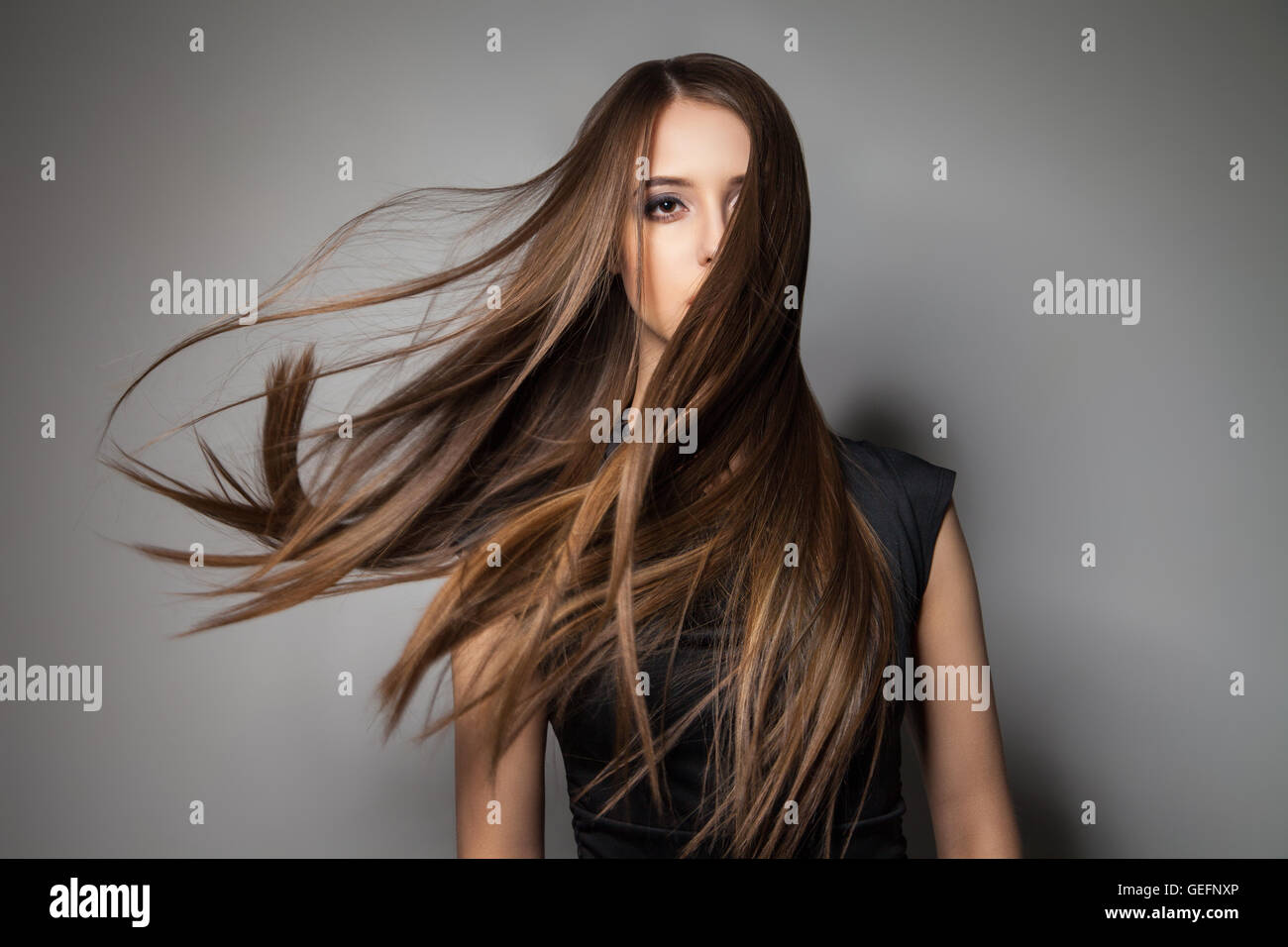 Brunette model with windy hair Stock Photo - Alamy
