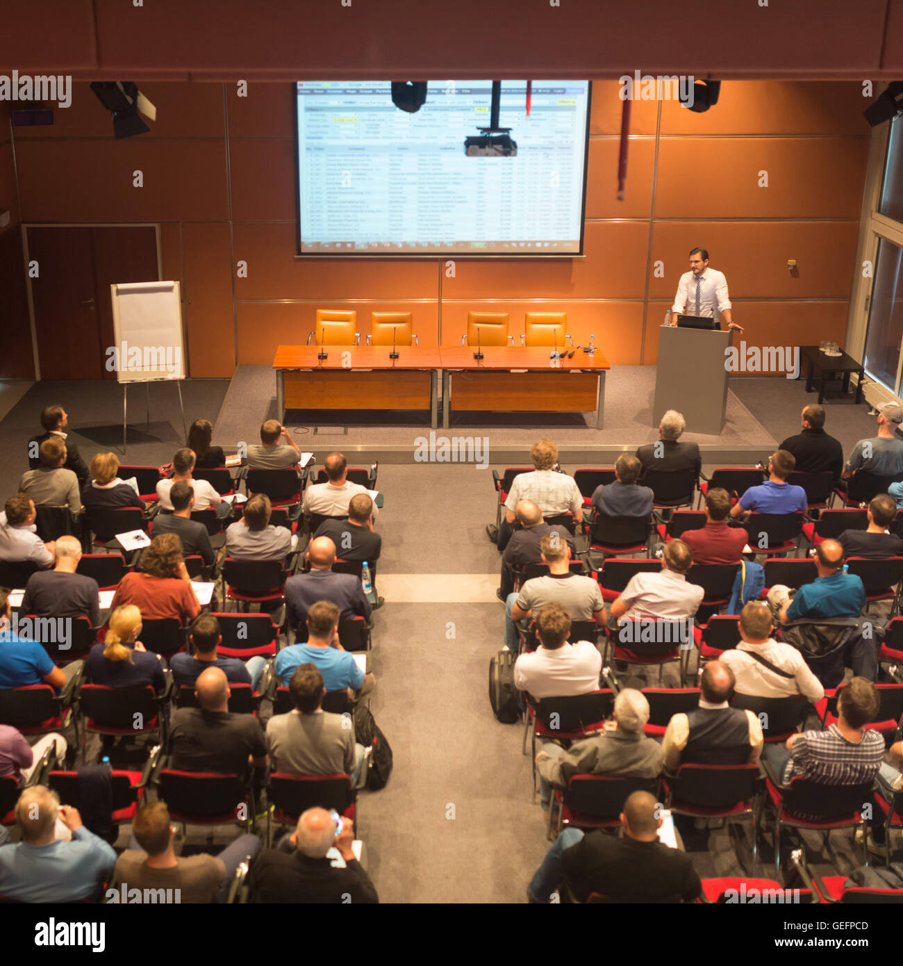 Business speaker giving a talk in conference hall Stock Photo - Alamy