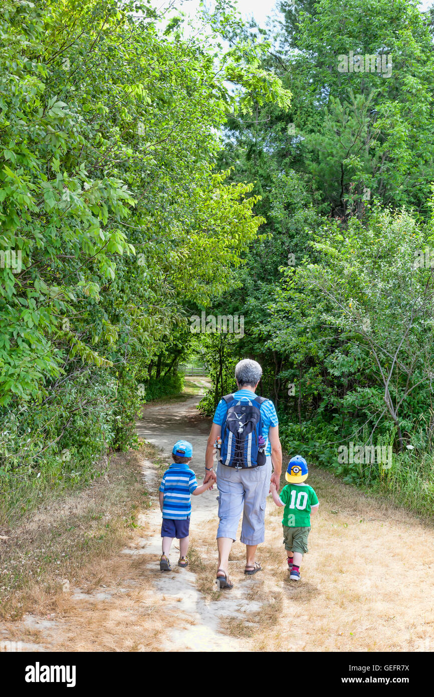Mother with two children having fun in a outdoor nature park on field ...