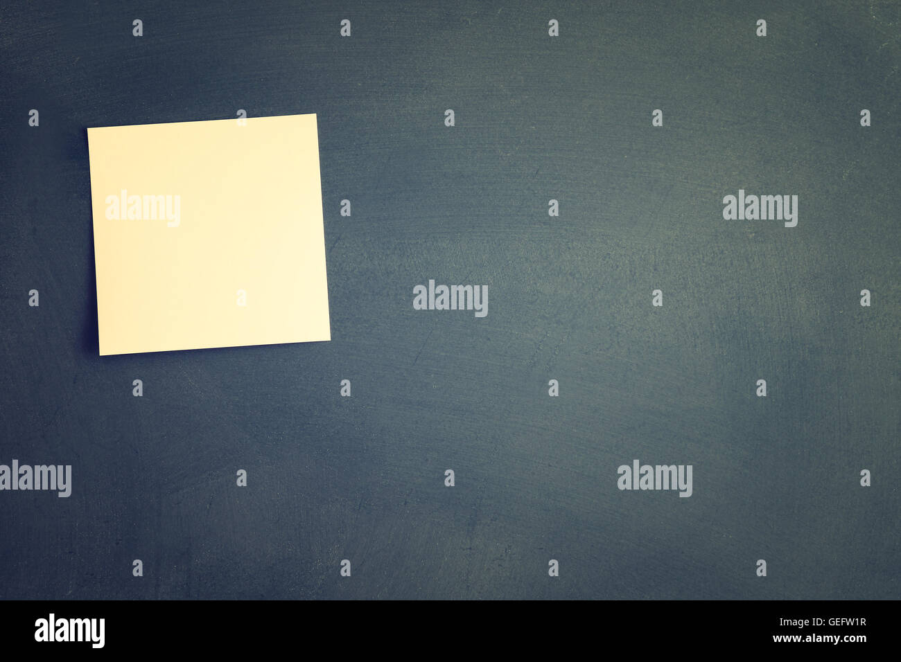 One blank sticky note attached to blackboard Stock Photo - Alamy