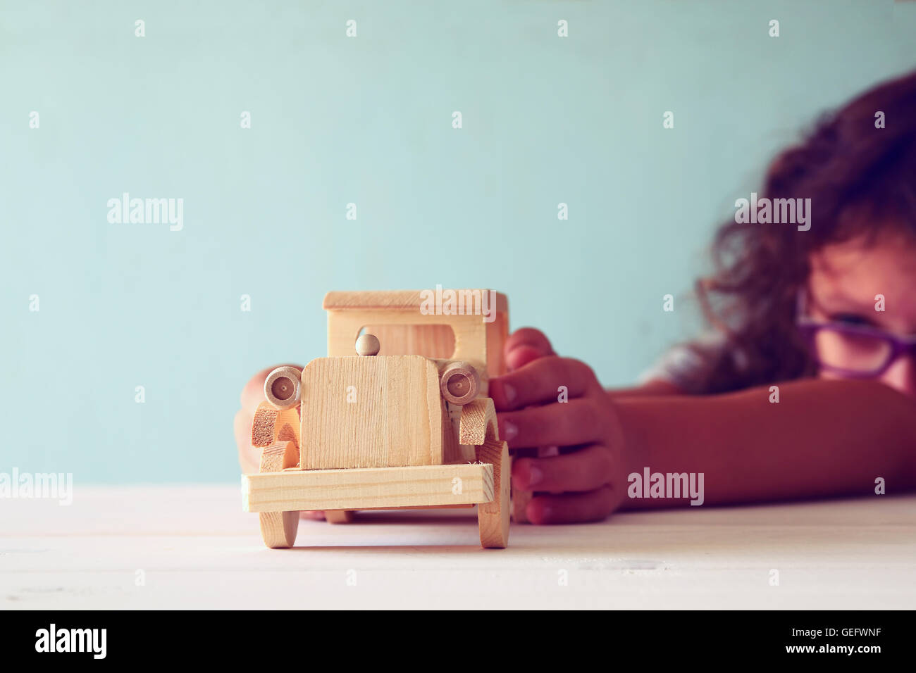Photo of cute kid playing with old wooden toy car. Selective focus ...