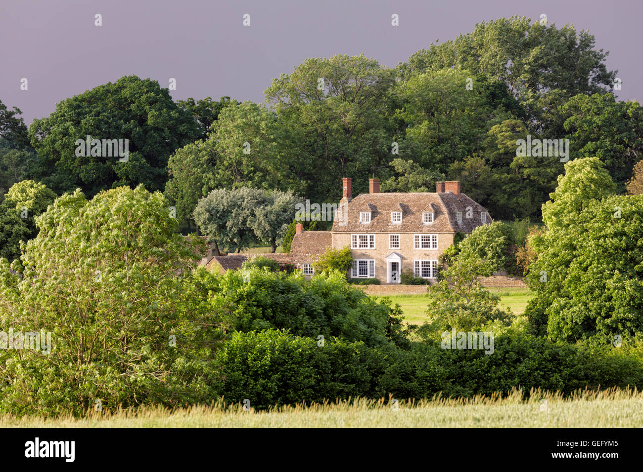Farmhouse in storm light Stock Photo - Alamy