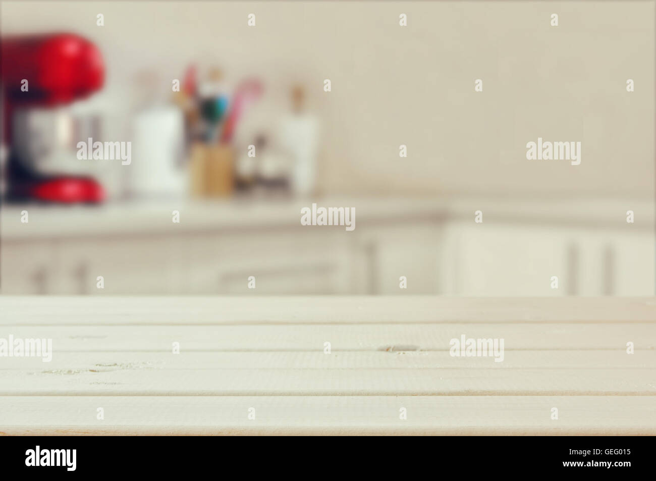 Wooden table in front of defocused white retro kitchen background ...