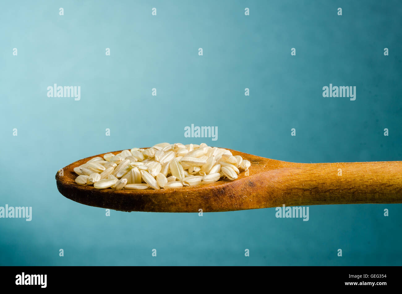 rice in a spoon, close up, color background Stock Photo - Alamy