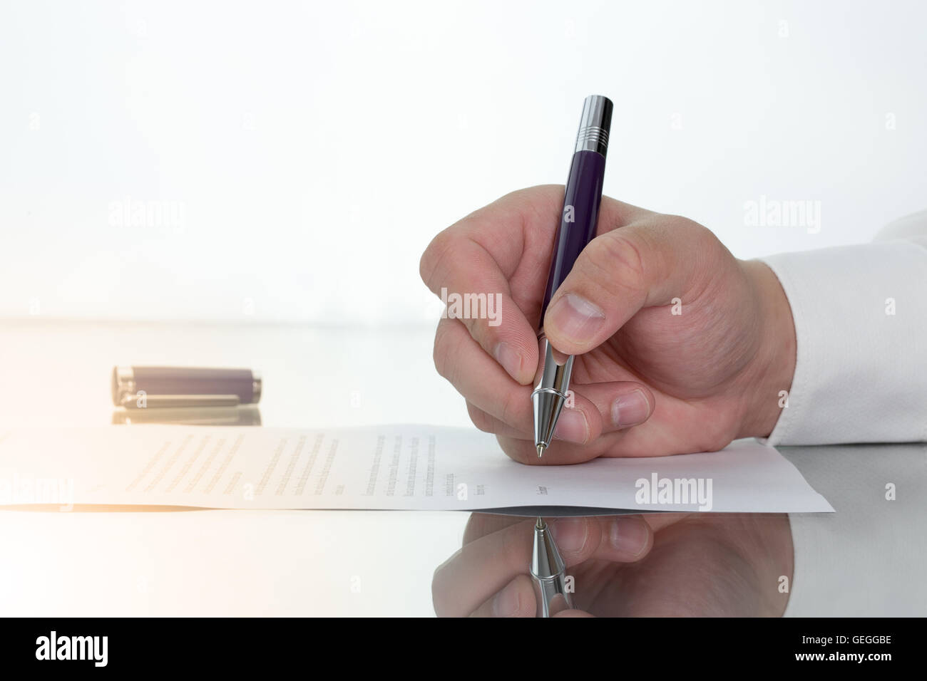 Hand signing check hi-res stock photography and images - Alamy