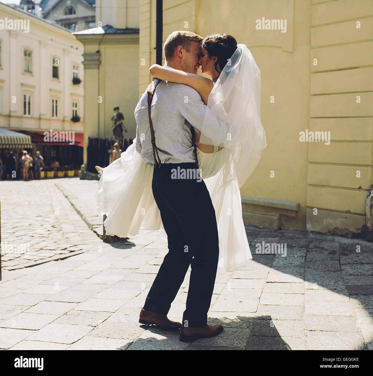 Groom carries bride in arms hi-res stock photography and images - Alamy