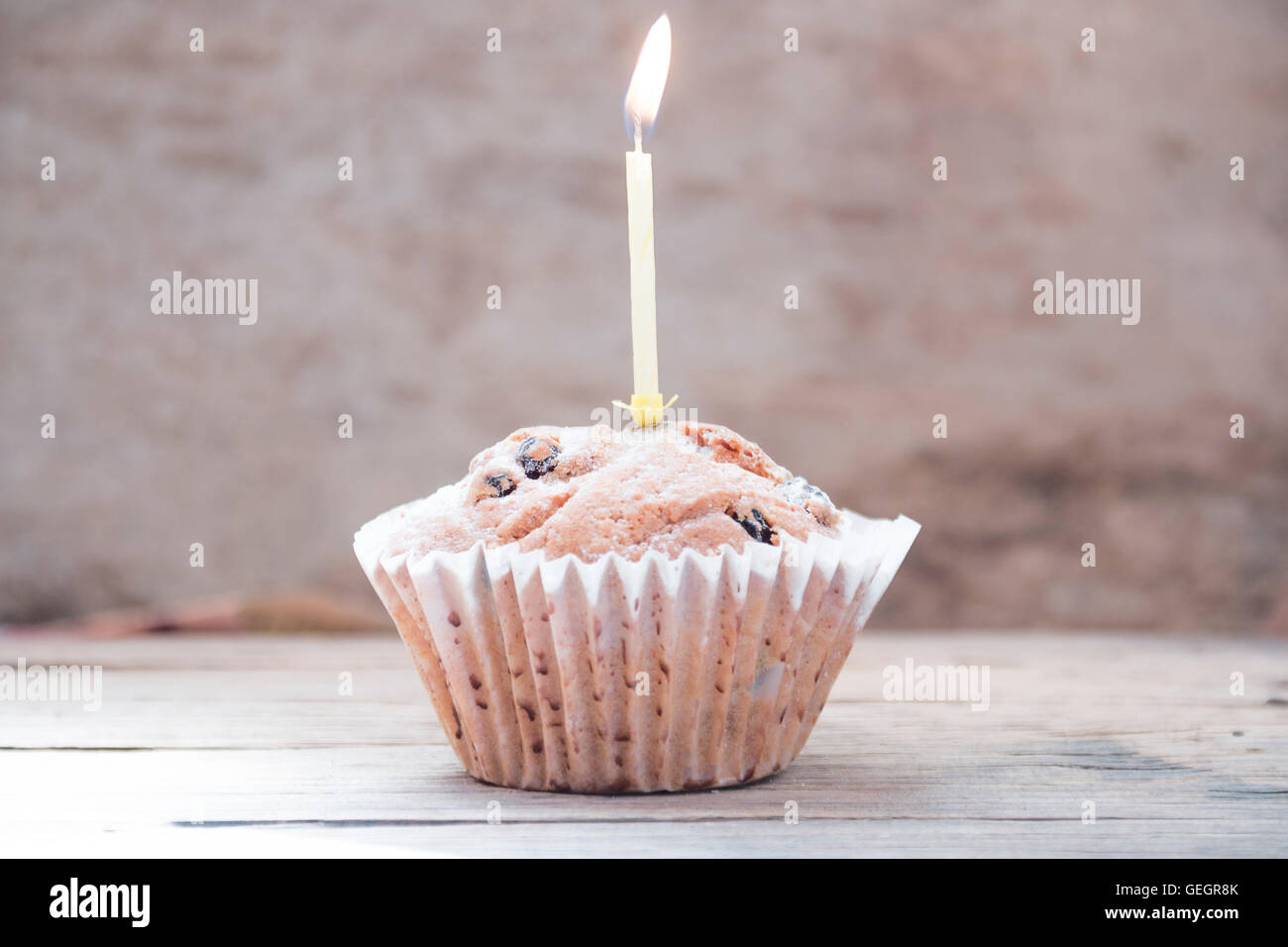 Birthday cupcake with candle Stock Photo - Alamy