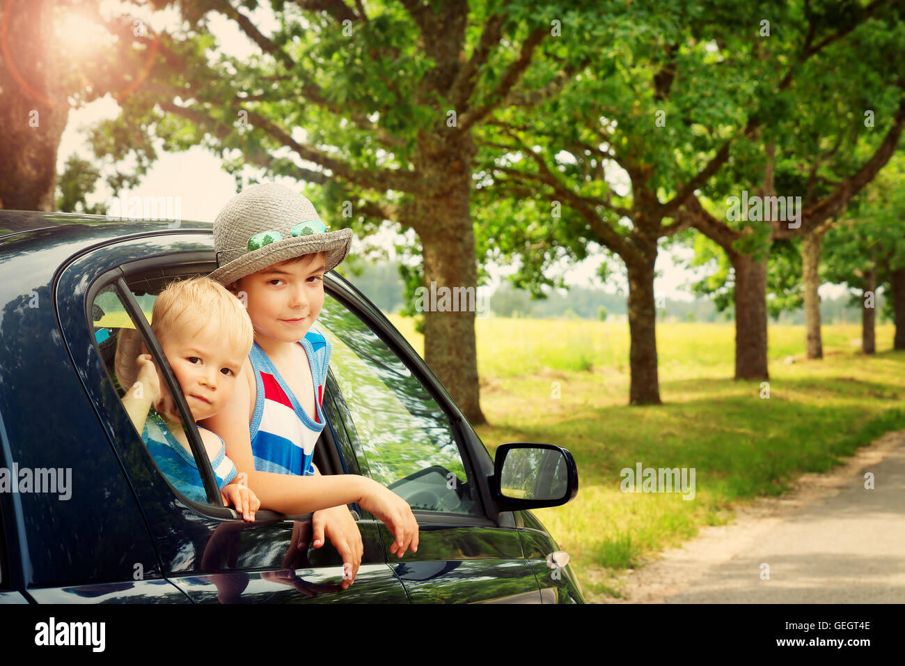 Children looking out of window from a car Stock Photo - Alamy