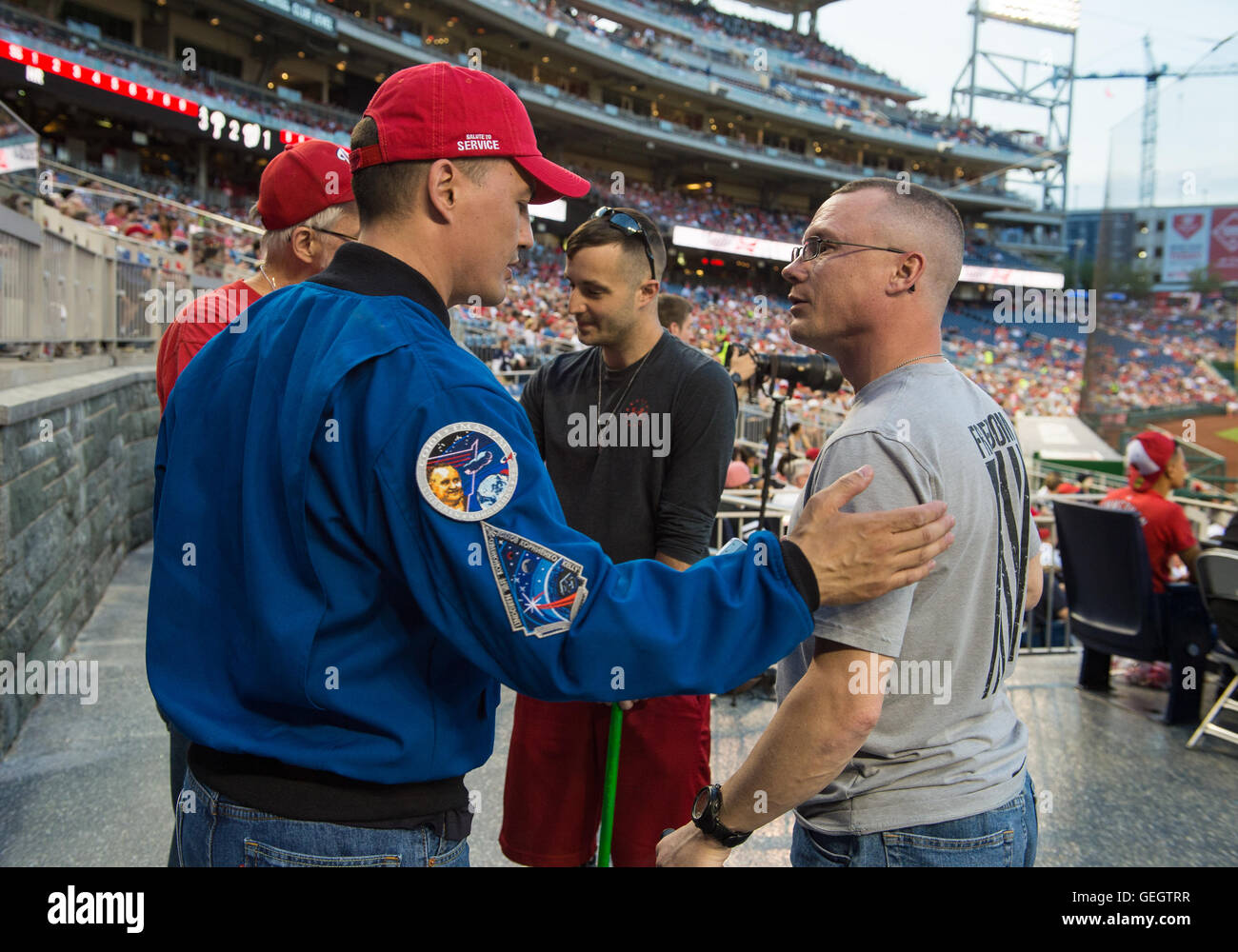 NASA astronaut Kjell Lindgren throws the ceremonial first pitch at a ...