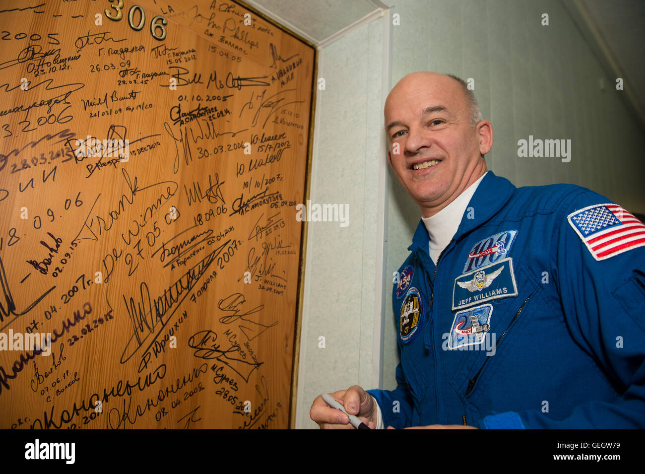 NASA astronaut Jeff Williams and other crew members sign the door at ...