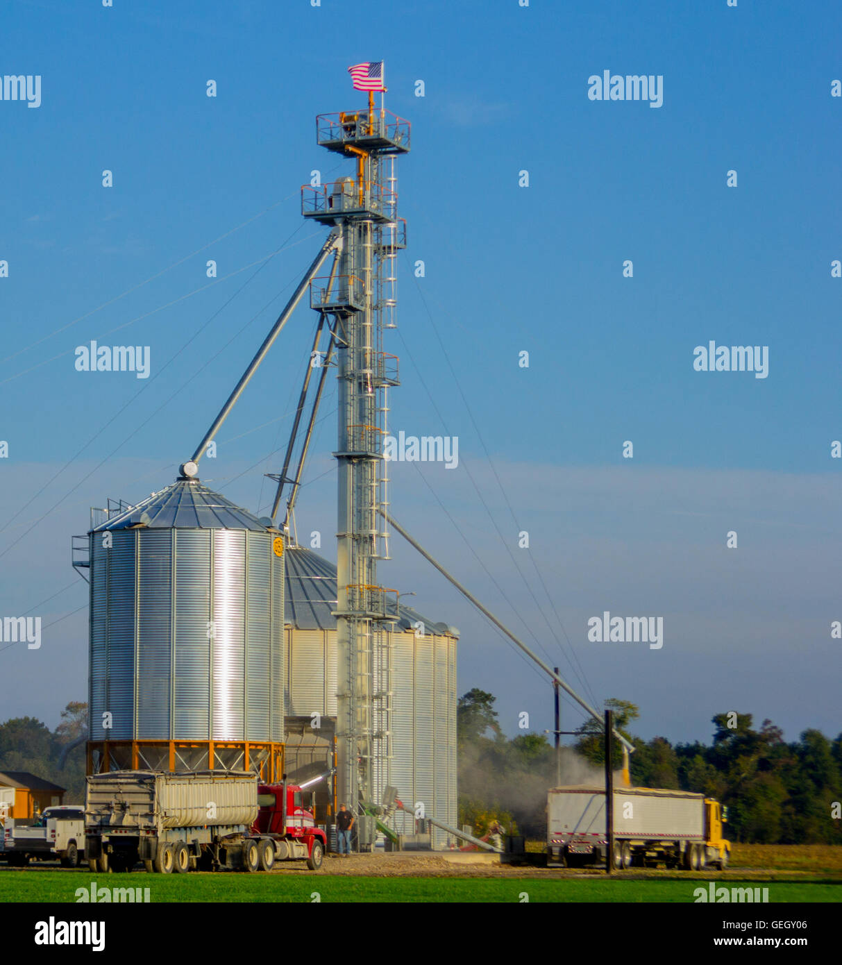 Farmer fills trucks with corn from his silo Stock Photo - Alamy