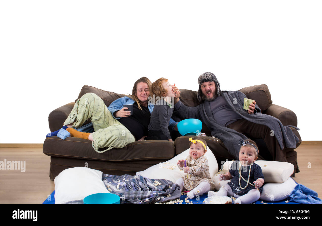 exhausted tired parents with messy child and babies on couch Stock ...